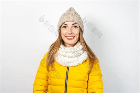 穿着黄色羽绒服头戴浅色背景帽子的年轻女子图片 包图网企业站