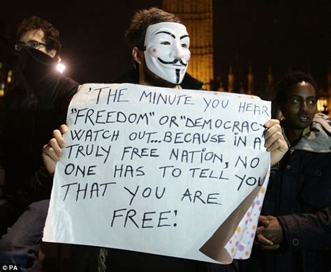 Russell Brand Joins Anonymous Protesters As Fireworks Are Fired At