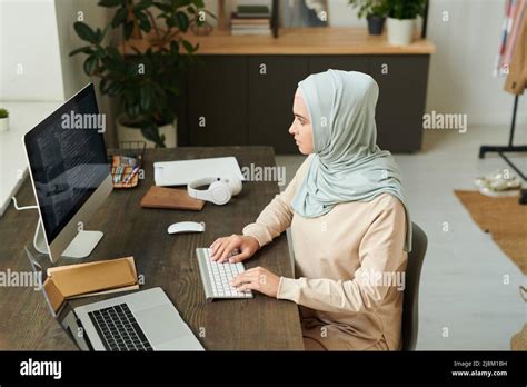 Horizontal High Angle View Shot Of Modern Young Muslim Woman Working On