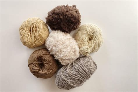 Premium Photo Top View Of Skeins And Balls Of Different Types Of Yarn For Hand Knitting On A