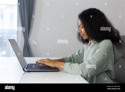 Focused BIPOC Woman Typing Text On Notebook Keyboard Programmer Coding