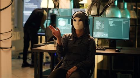 Premium Photo Female Hacker With Anonymous Mask Using Hologram To