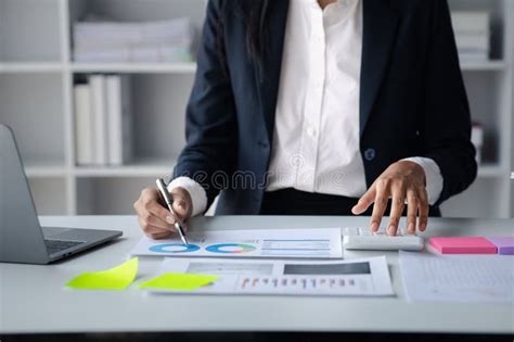 A Female Financier Is Reviewing Company Financial Documents Monthly