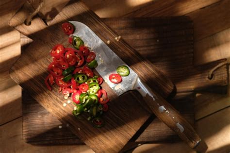 Premium Photo Sliced Red And Green Chilies On A Teak Wood Cutting