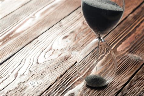 Premium Photo Modern Hourglass On Wooden Surface