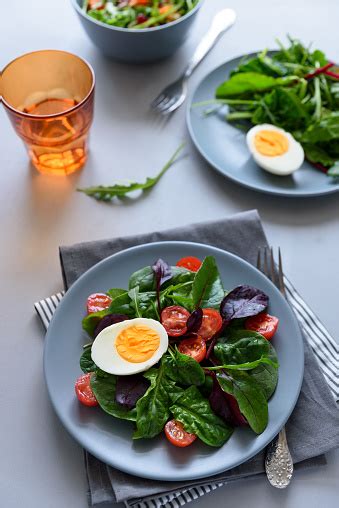 시금치 Arugula 비트 잎 토마토와 계란 회색 나무 배경에 샐러드 믹스 채식 음식 개념입니다 선택적 초점 0명에 대한 스톡