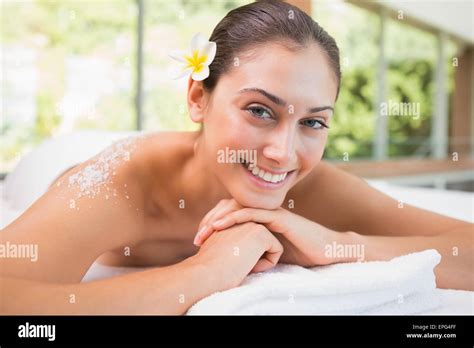 Beautiful Smiling Brunette Lying On Massage Table With Salt Scrub On