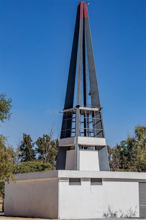 Small Building With An Open Triangular Steel Structure On Roof Against