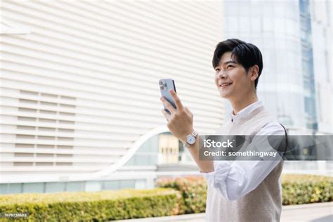 사무직 근로자는 야외에서 정보를 수신하기 위해 휴대 전화를 사용합니다 25 29세에 대한 스톡 사진 및 기타 이미지 25