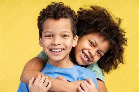 Premium Photo Happy Little Sister Hugging Her Small Brother While