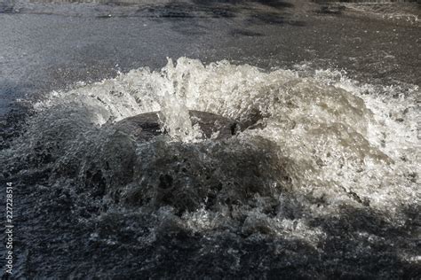 Water Flows Out Of Road Sewage Hatch Drainage Fountain Of Sewage