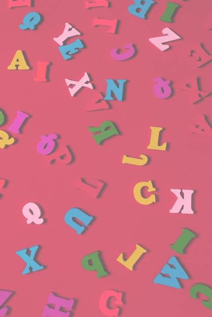 Premium Photo Random Colorful Alphabet On A Red Background Colorful