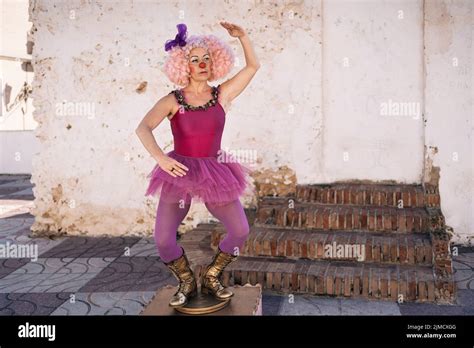 Full Body Of Mature Female Mime Artist In Tutu And Pink Wig With Bright