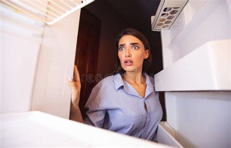 Shocked Girl Looking At Her Empty Fridge Shelves In Despair Stock Image Image Of Desperate