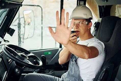 Professional Uniformed Man Working On The Borrow Pit During Daylight Hours As A Driver Photo
