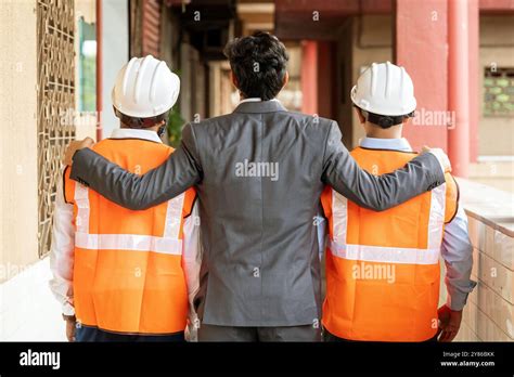 A Construction Team Including An Architect Site Engineer And Construction Worker Or