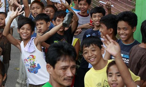 Hes Smiling Now Filipino Youths Wait In Line To Take Part In Mass
