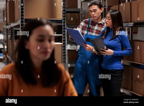 Retail Storehouse Workers Picking Customer Order Using Checklist On