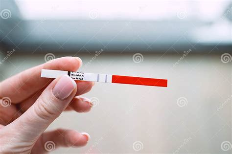 Woman Hand Holding Positive Pregnancy Test With Two Lines On It