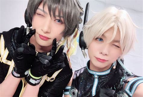 Two People Wearing Headphones And Gloves Posing For The Camera