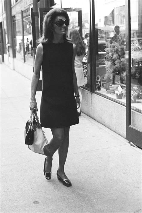 Jacqueline Kennedy Onassis Wearing A Black Dress Sunglasses And The Gucci Jackie” Handbag In