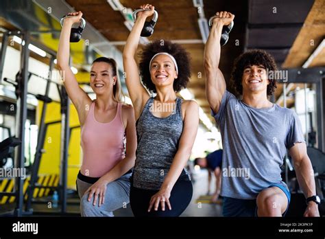 Group Of Fit People Lifting Dumbbells During An Exercise Class At The