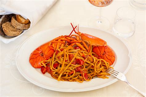 이탈리아 고급 해산물 저녁 식사 랍스터와 토마토를 곁들인 파스타 링귄 장미 와인과 물 한 잔 랍스터 해산물에 대한 스톡 사진 및 기타 이미지 Istock