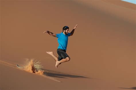 Premium Photo Man Jumping Over Desert