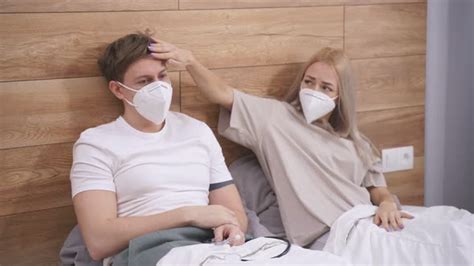 Worried Wife Take Care His Sick Husband While She Is Sitting On A Bed