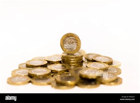 Stacks And Heaps Of British GBP Golden Coins Currency Money On White