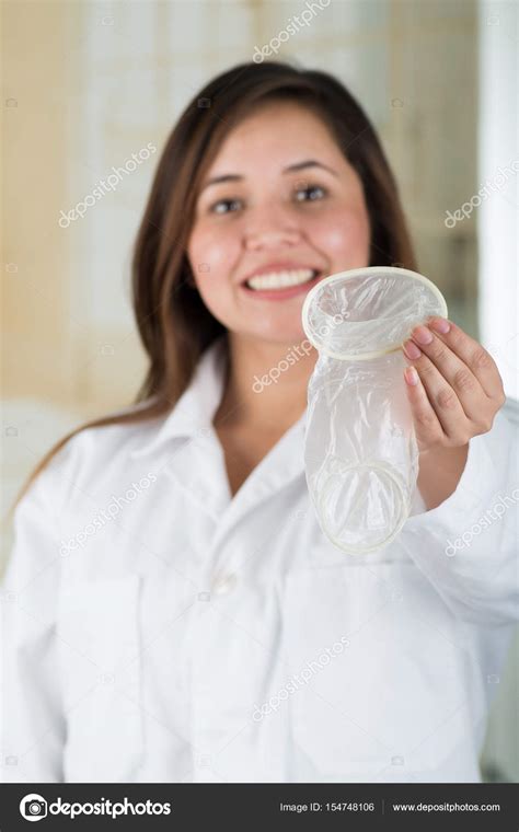 Mirroned Young Beautiful Doctor Holding An Open Female Condom Safe Sex