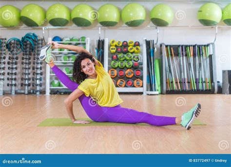 Attractive Young Brunette Female Athlete Doing Advanced Split