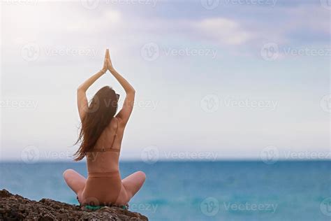 Young Woman With Long Hair Practicing Yoga On The Beach 18055010 Stock