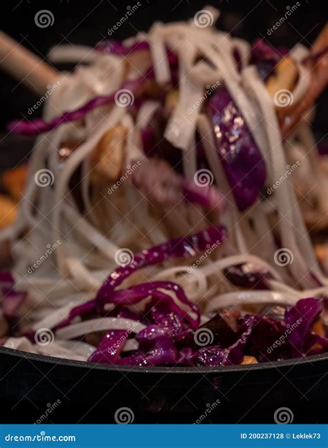 Cooking A Vegan Asian Pad Thai Stir Fry With Red Cabbage Tofu And