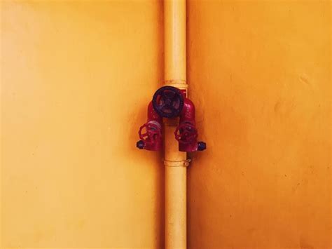 Premium Photo Close Up Of Pipeline In Corner Of Orange Wall