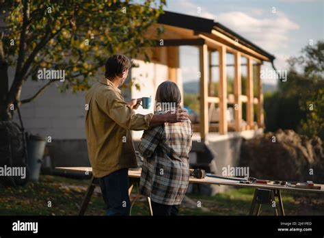 Mature Couple Looking At Their New House Under Construction Planning