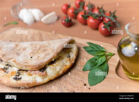 Italian Food Closed Calzone Pizza On Rustic Wooden Background On