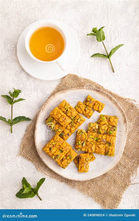 Traditional Iranian Dessert Sohan With Cup Of Green Tea On A Gray