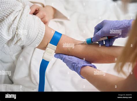 Nurse Giving Intramuscular Injection In Female Arm Stock Photo Alamy