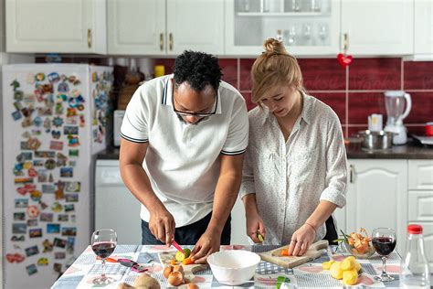 Couple Cooking Together In Kitchen By Stocksy Contributor Mihajlo