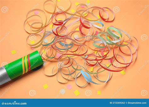 Beautiful Serpentine And Confetti Bursting Out Of Party Popper On Coral