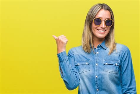 Young Beautiful Woman Wearing Sunglasses Over Isolated Background