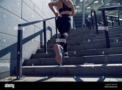 Strong Athletic Woman Trained Legs During Jogging On Stairs Stock