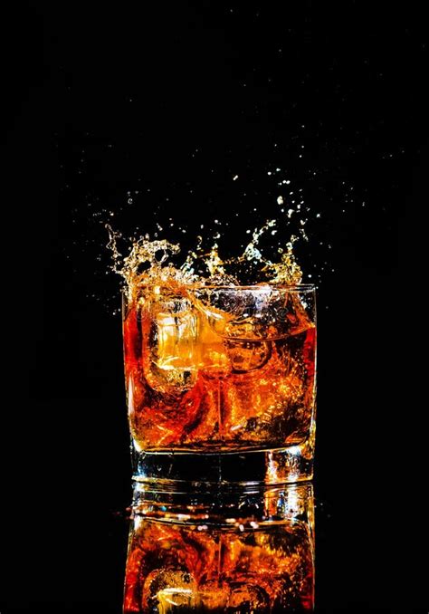 Whiskey With Splash On Black Background Brandy In A Glass Stock Image