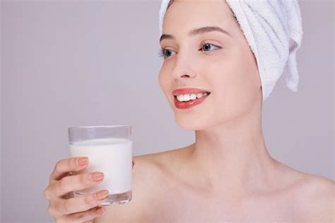 Premium Photo Cute Woman Holds A Glass Of Milk And Smiles