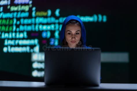 Hooded Anonymous Hacker Woman By Computer In The Dark Room At Night Cyberwar Concept Stock