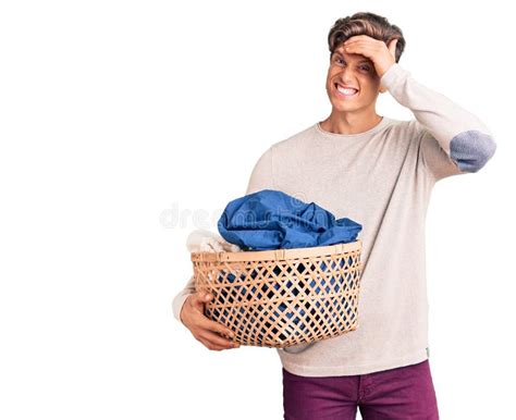 Young Handsome Man Holding Laundry Basket Stressed And Frustrated With