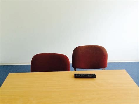 Premium Photo Remote Control On Wooden Table In Room