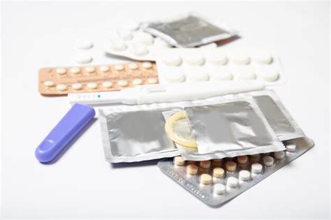 Premium Photo Contraceptive Pills And Condoms On A White Background