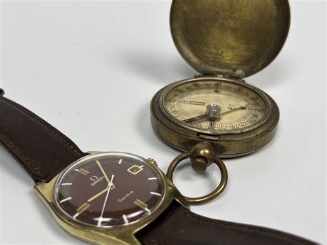 A Vintage Omega Swiss Watch And An Antique Brass Compass 40870313